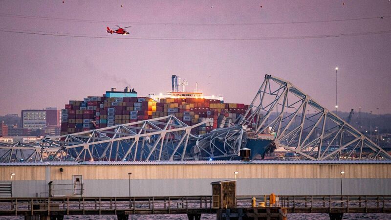 Two pulled from water after Baltimore bridge hit by cargo ship collapses